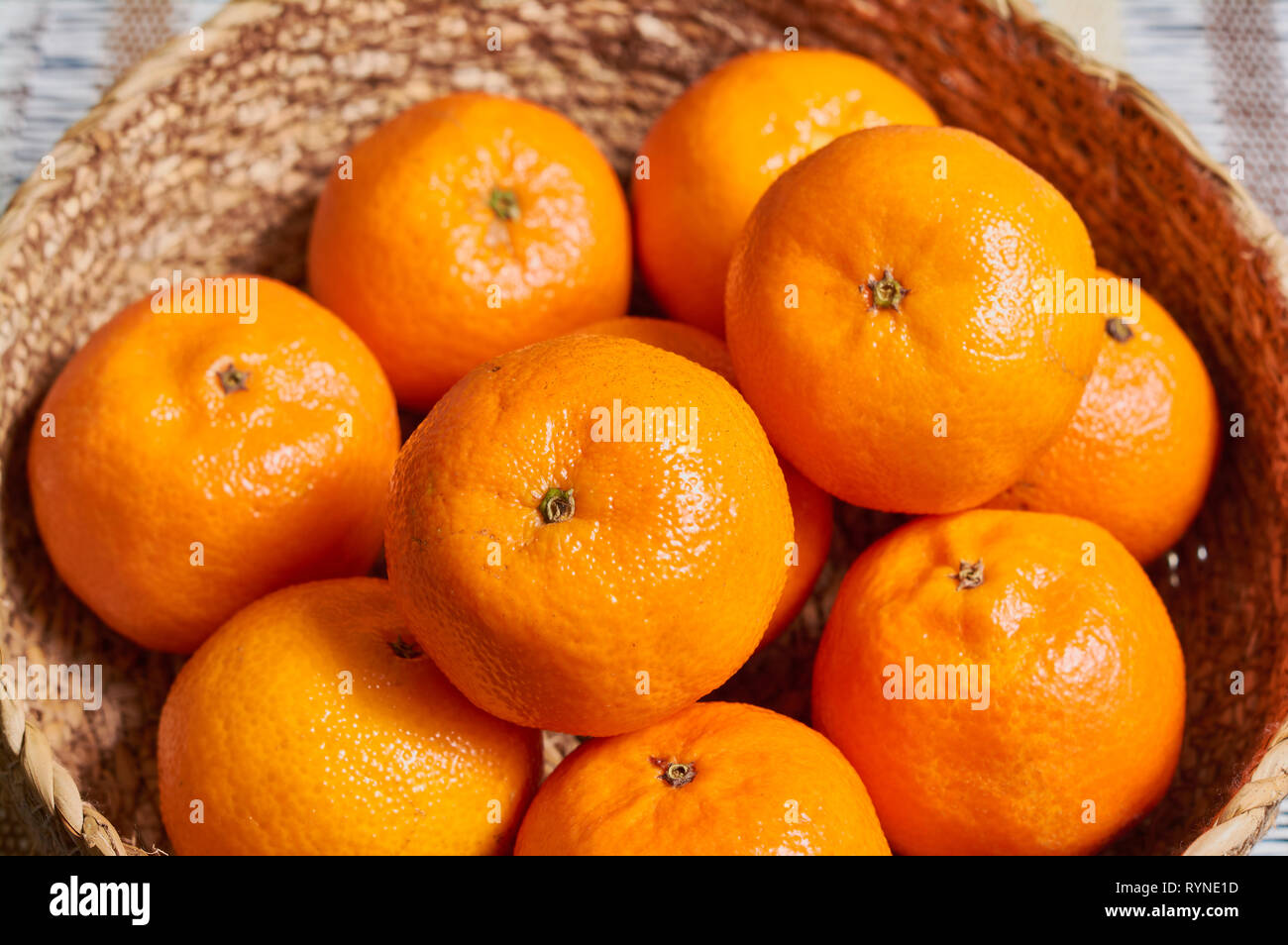 tangerine basket with artisan tablecloth background Stock Photo - Alamy