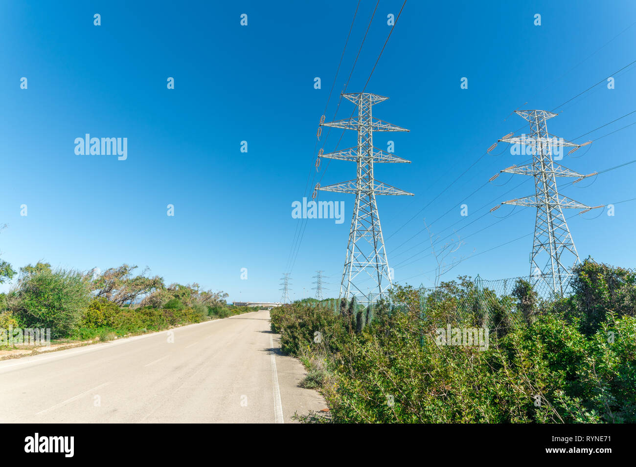 country road near elettric pylons in a sunny morning Stock Photo - Alamy