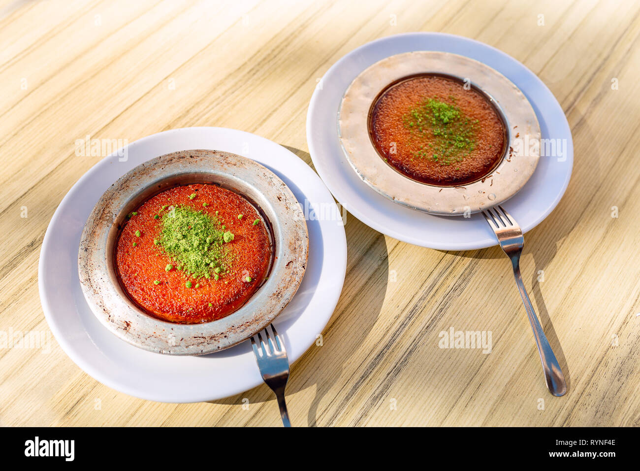 Turkish dessert kunefe, kunafa, kadayif with pistachio powder and ...