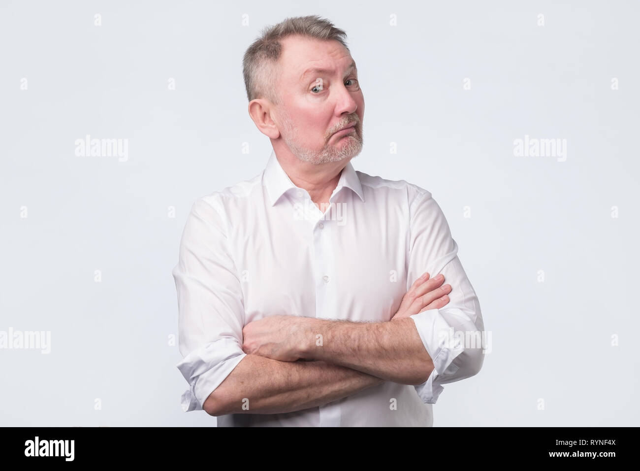 Doubtful senior man looking with disbelief expression Stock Photo - Alamy