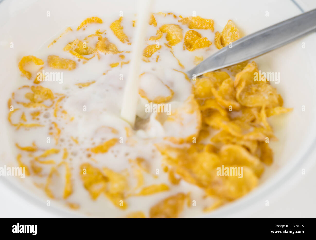 pouring milk into Corn flake cereal breakfast Stock Photo - Alamy