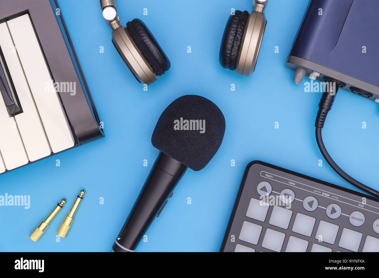 Music studio recording equipment on blue surface Stock Photo - Alamy