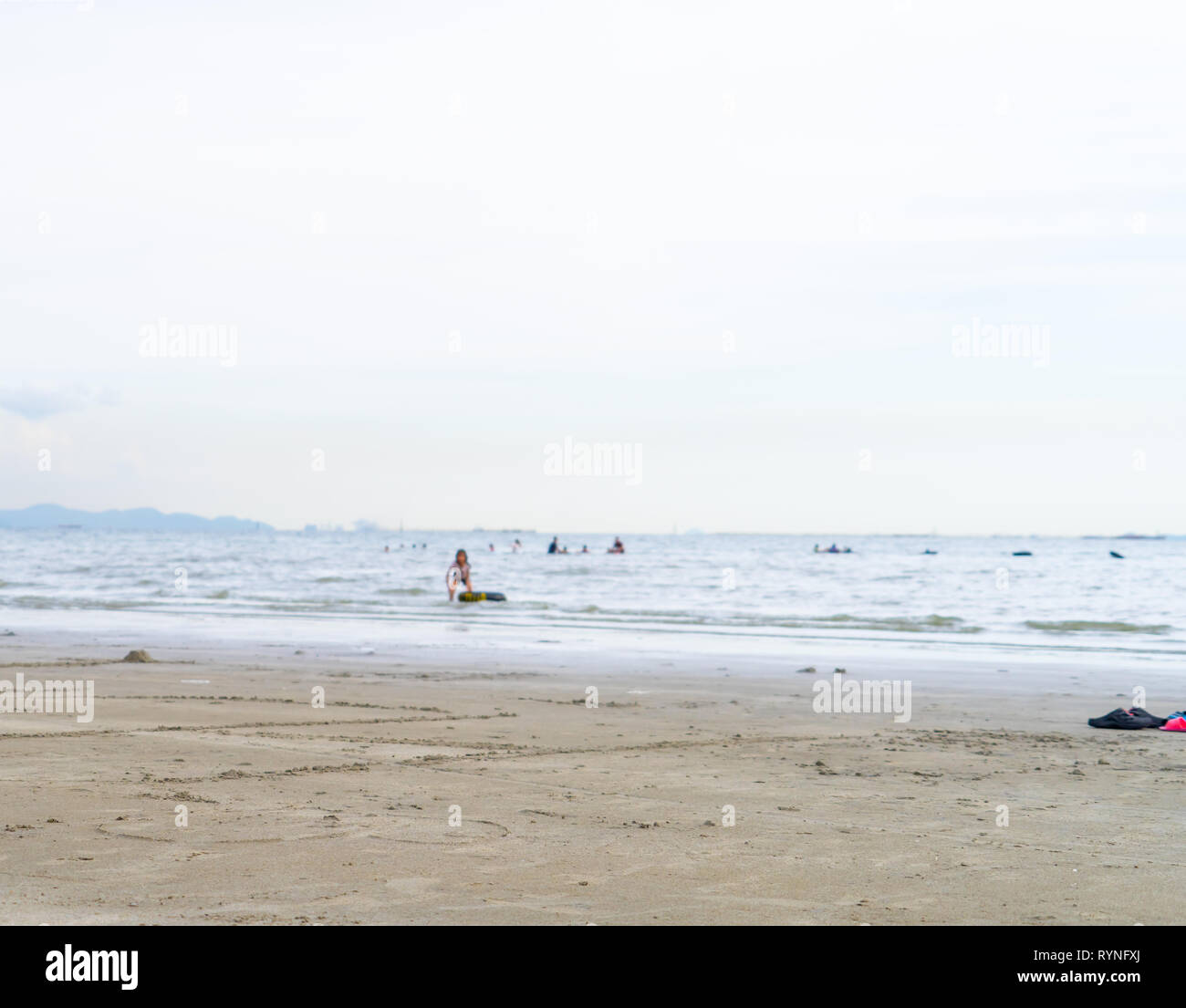Island beach wave with people playing water sport Stock Photo - Alamy