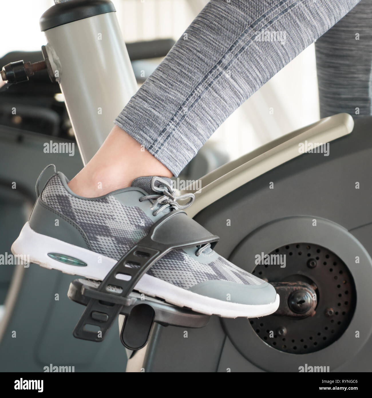 Woman legs spinning on Fitness gym bike machine Stock Photo - Alamy
