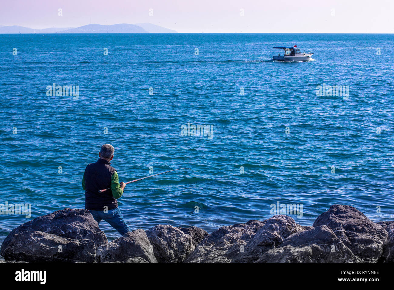 Fisherman and boat in the sea.Embankment in Istanbul Stock Photo - Alamy