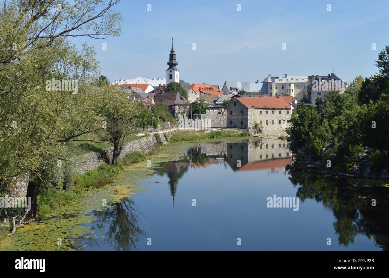 Town on a river bank Stock Photo - Alamy