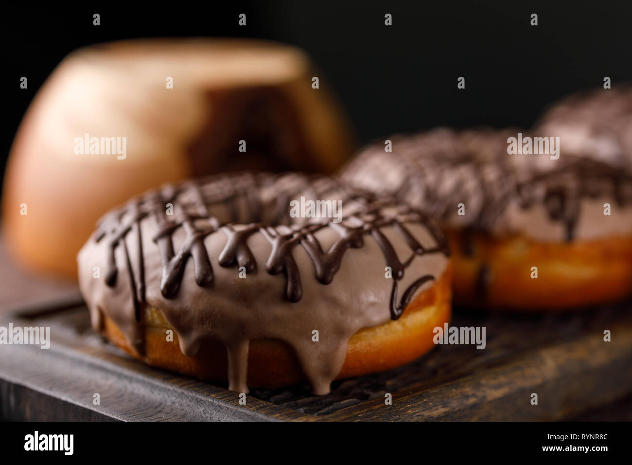 Cookery, baking and food concept - closeup. Donuts in the glaze on the ...