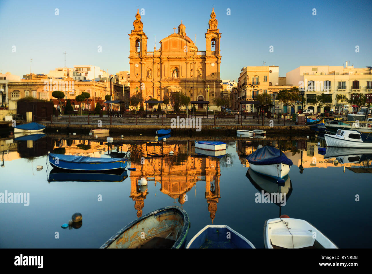 Msida Parish Church at sunny morning, Malta. February 2019. Blue boats ...