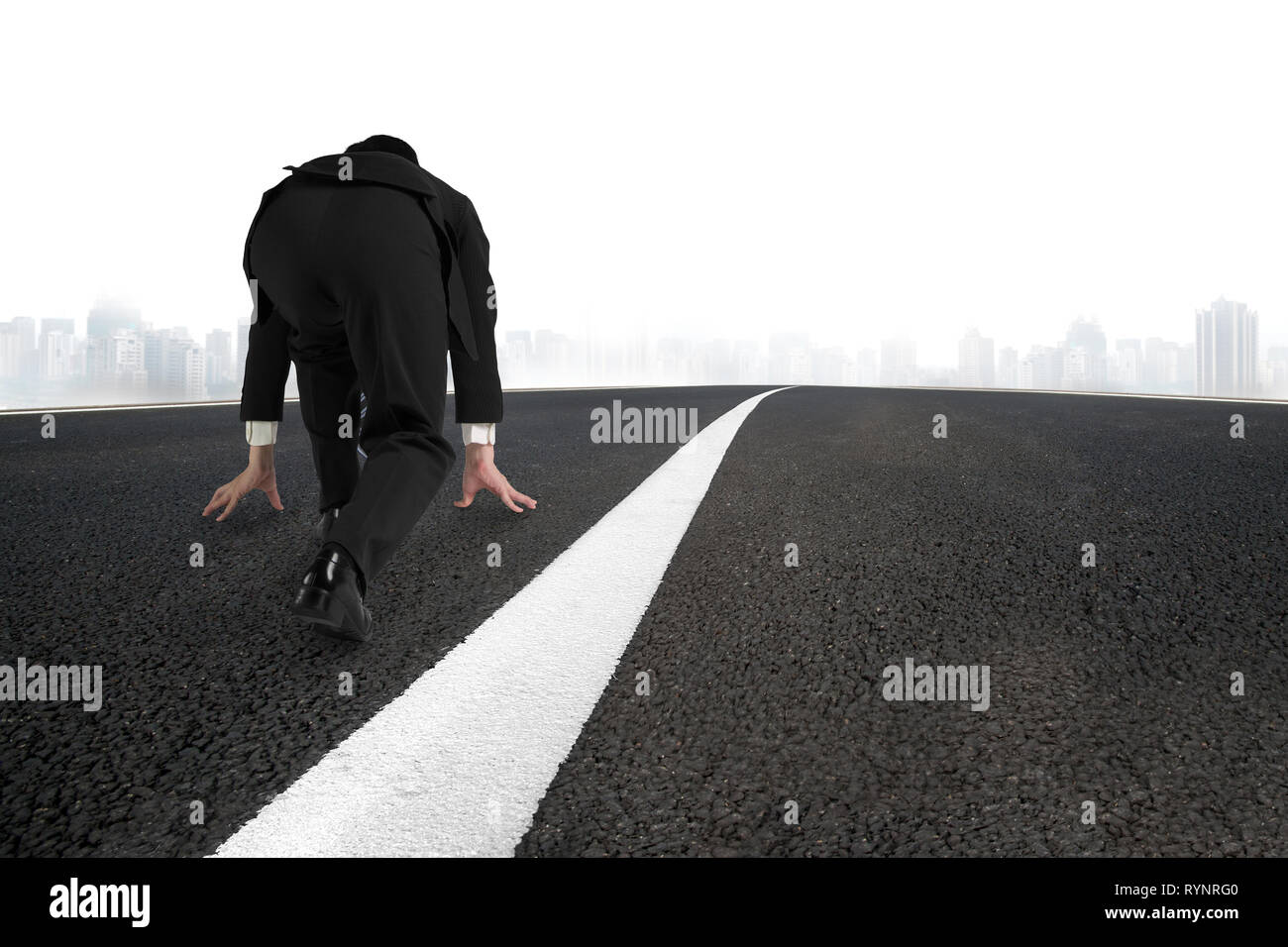 Businessman ready to run on asphalt road with white line and urban ...