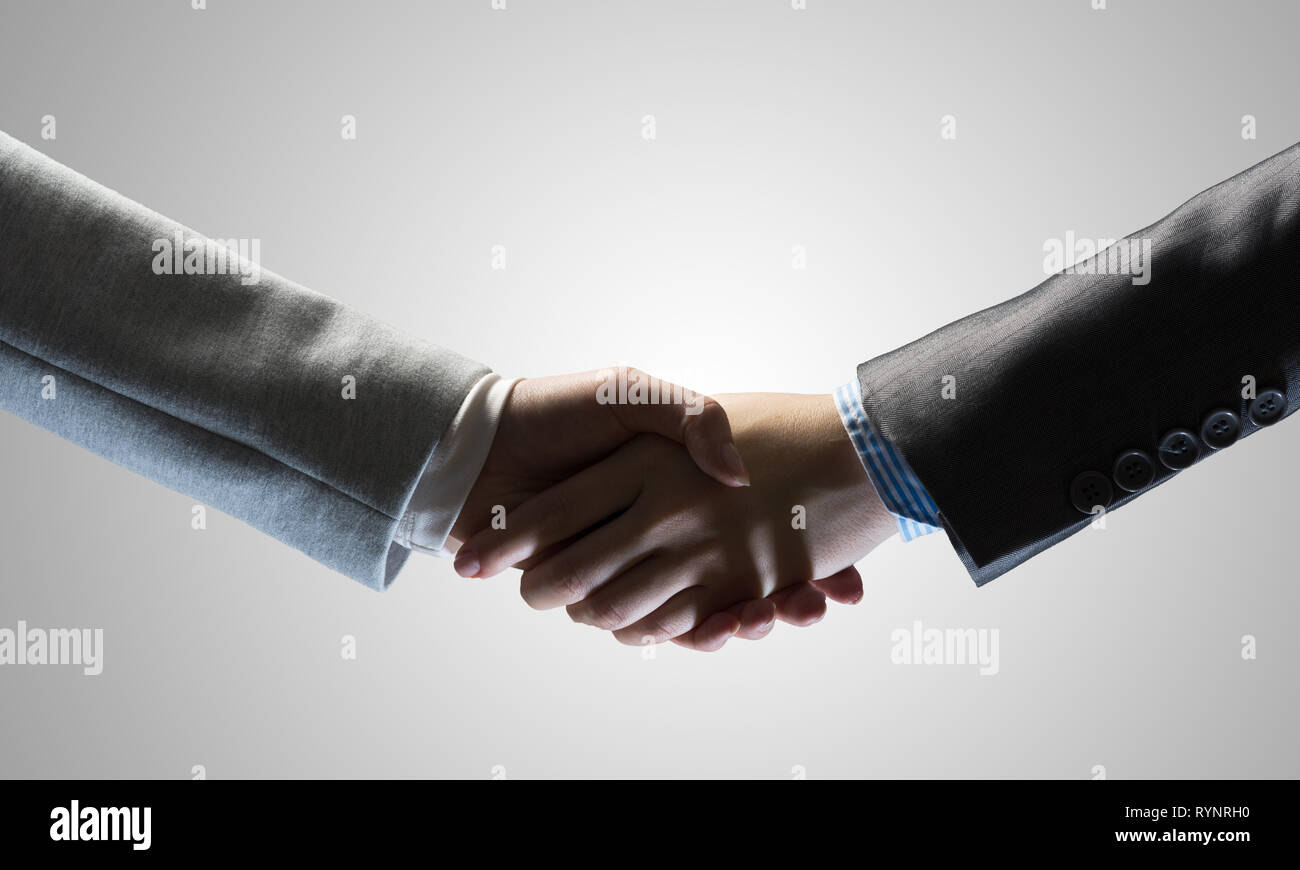 Business handshake as idea for unity and cooperation or greeting. Mixed ...