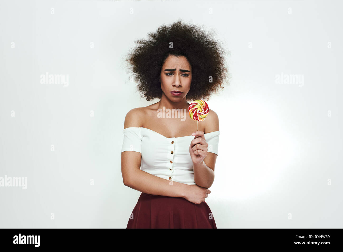 I need to stop eat sweets. Angry afro american woman looking at ...