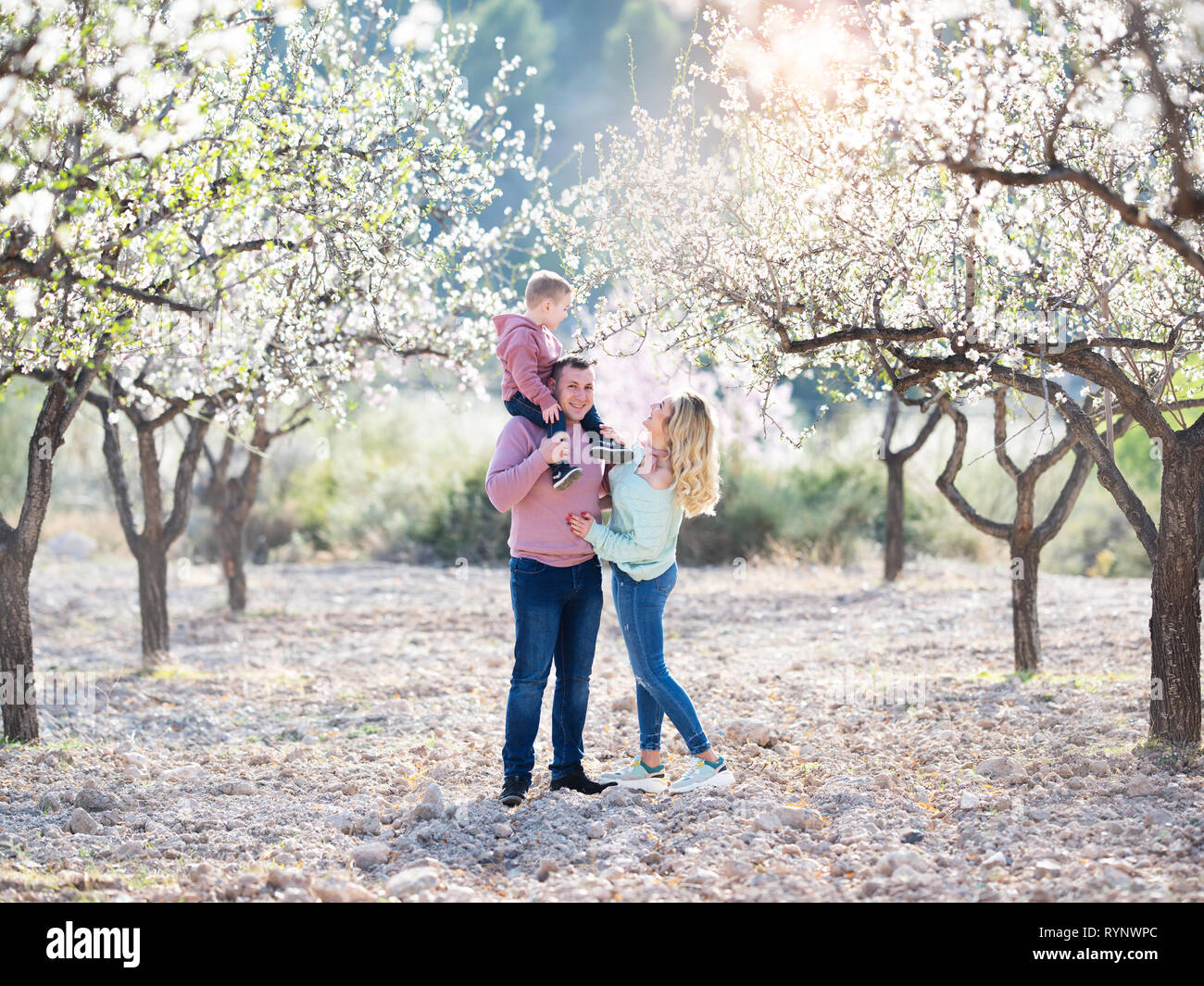 Happy beautiful family walks in blooming gardens Stock Photo - Alamy Happy beautiful family walks in blooming gardens Stock Photo - Alamy