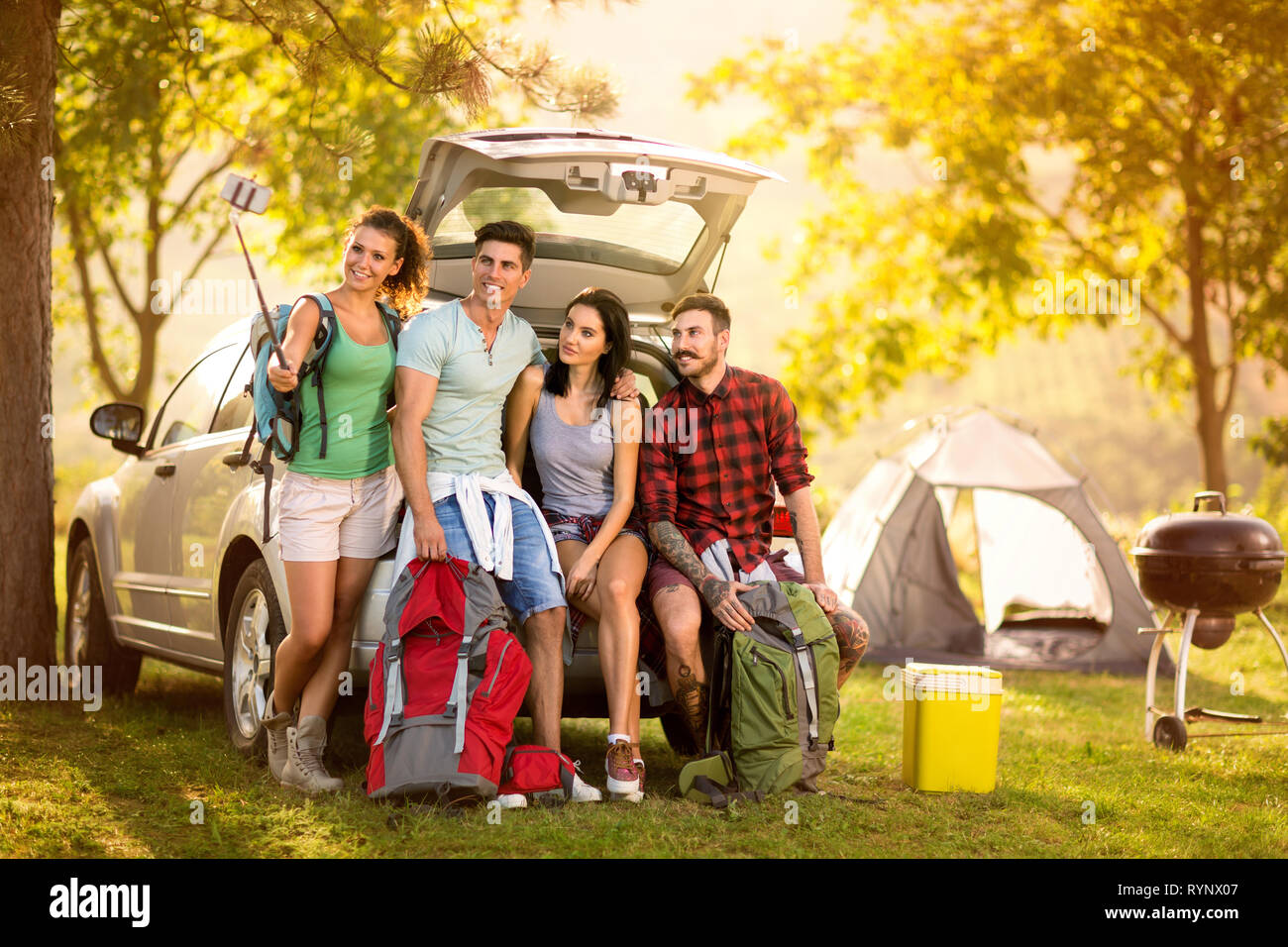 Group of young people arrived on camping trip and making selfie ...