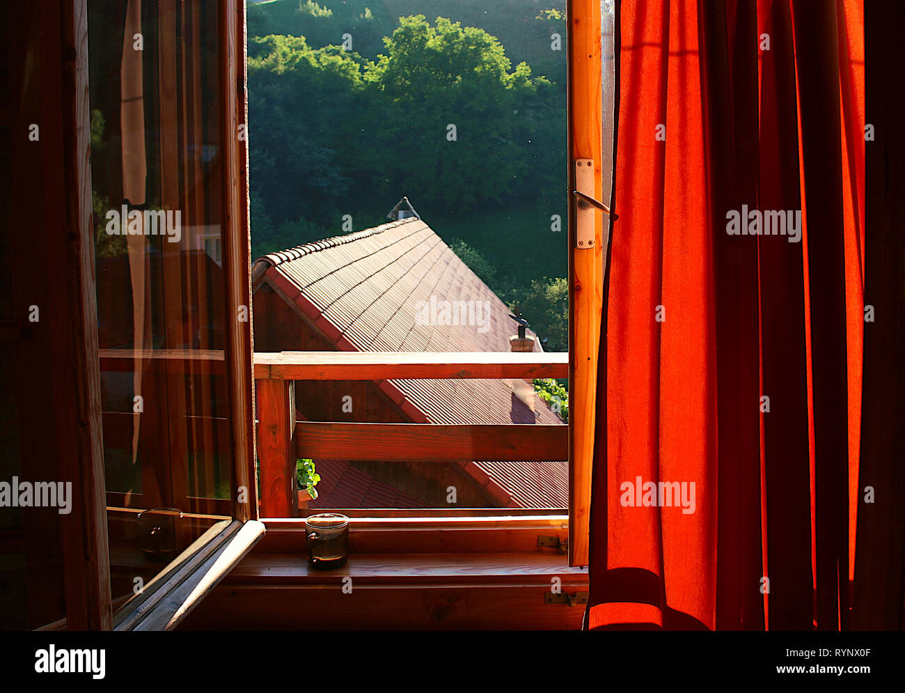 Morning sun peeking through the window with a cup of coffee on the ...