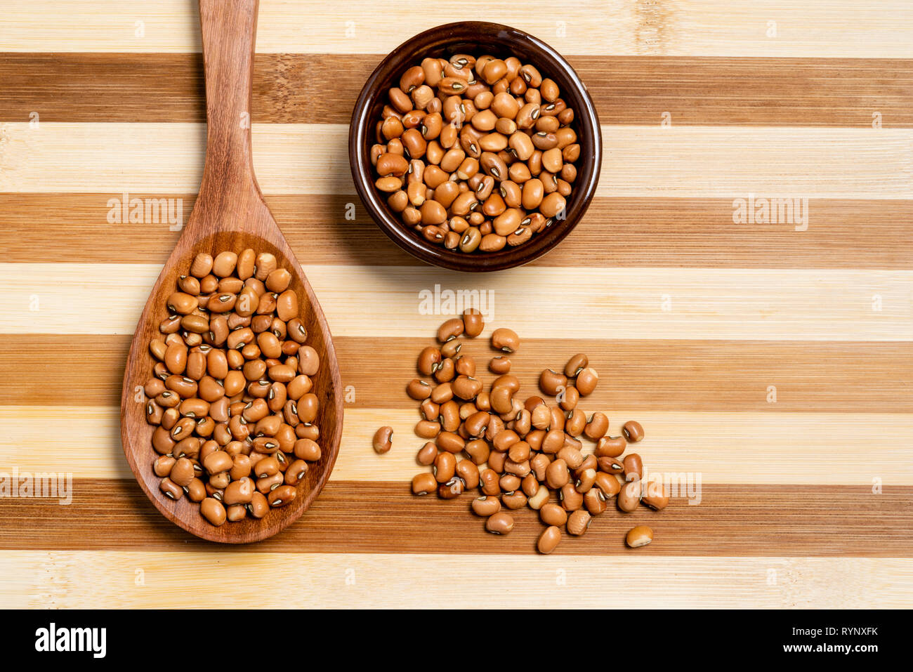 Bean rope in pot and wooden scoop on bamboo wood background Stock Photo ...