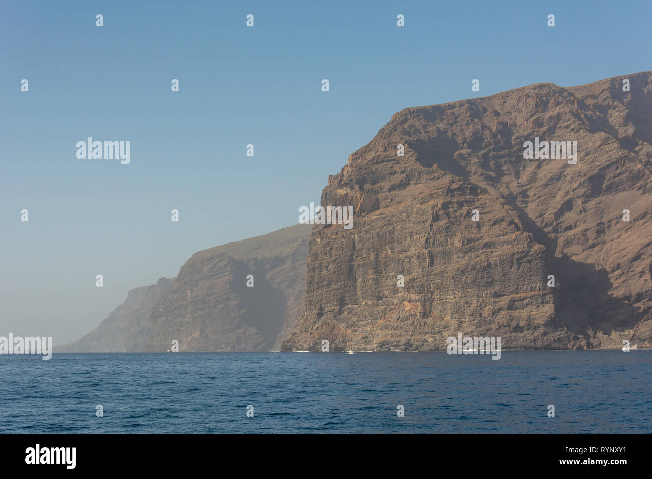 Sheer steep cliffs rising above the sea Stock Photo - Alamy