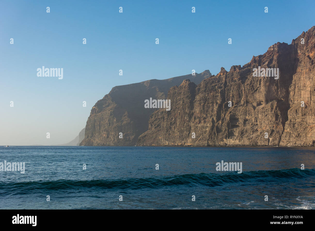 Sheer steep cliffs rising above the sea Stock Photo - Alamy