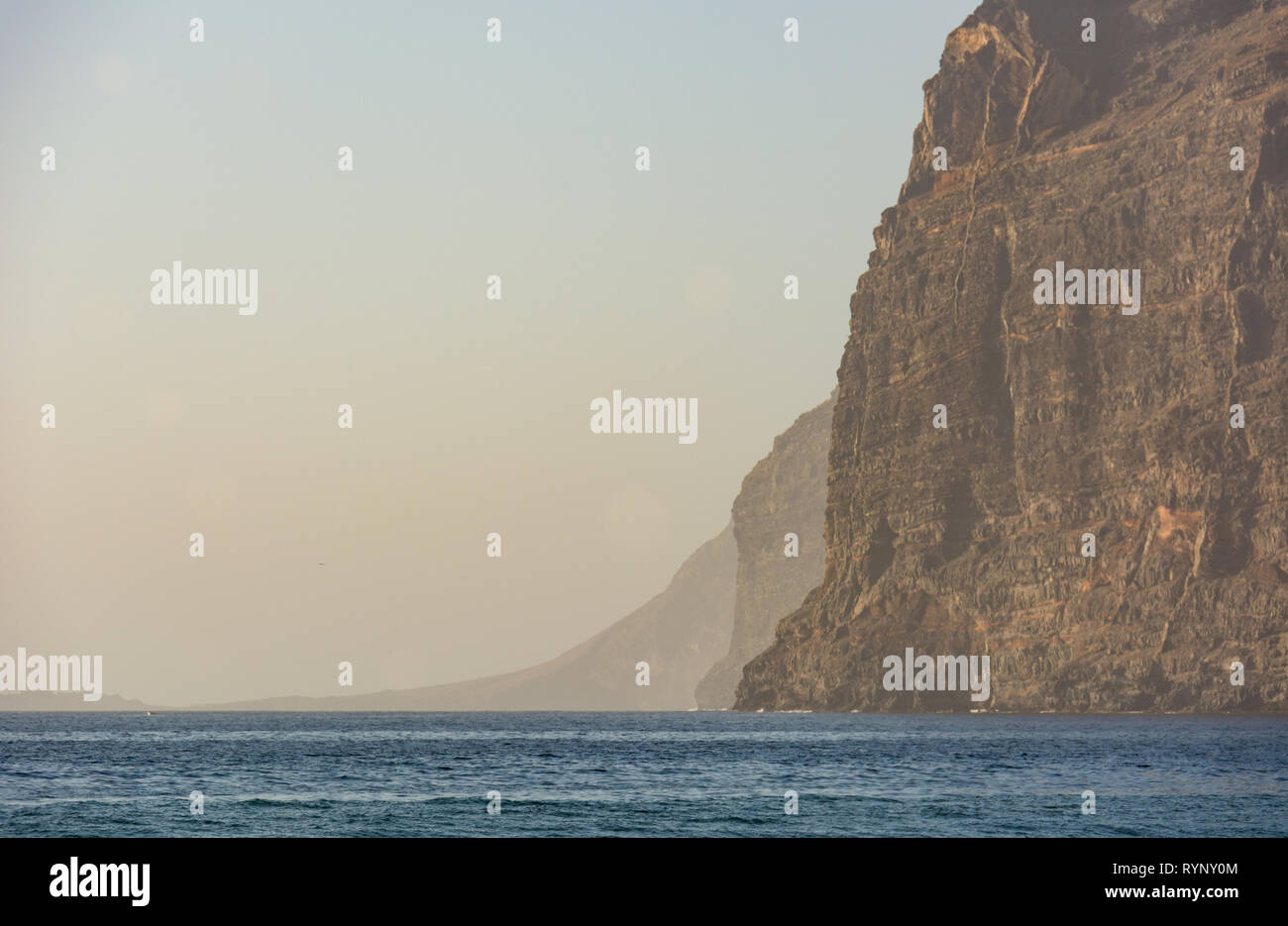 Sheer steep cliffs rising above the sea Stock Photo - Alamy