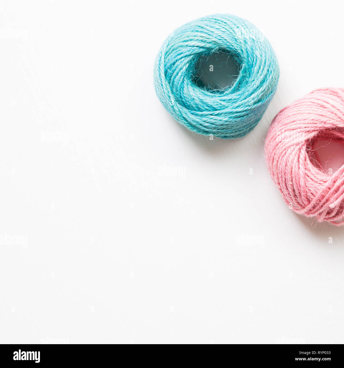 Pink and green string roll thread reel isolated on white background ...