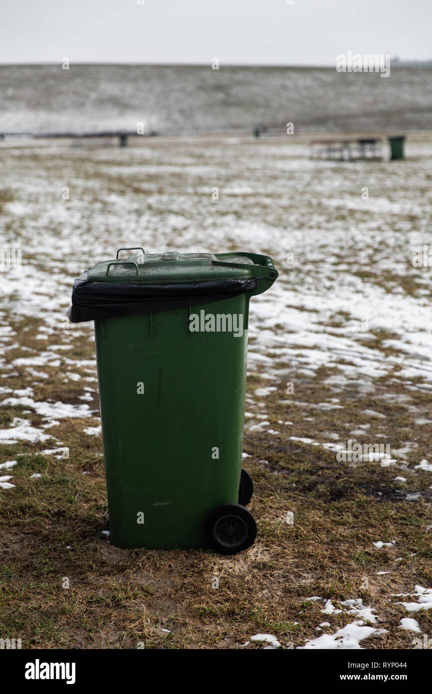 Blank ad space trash can standing in a picnic field in Winter Stock ...