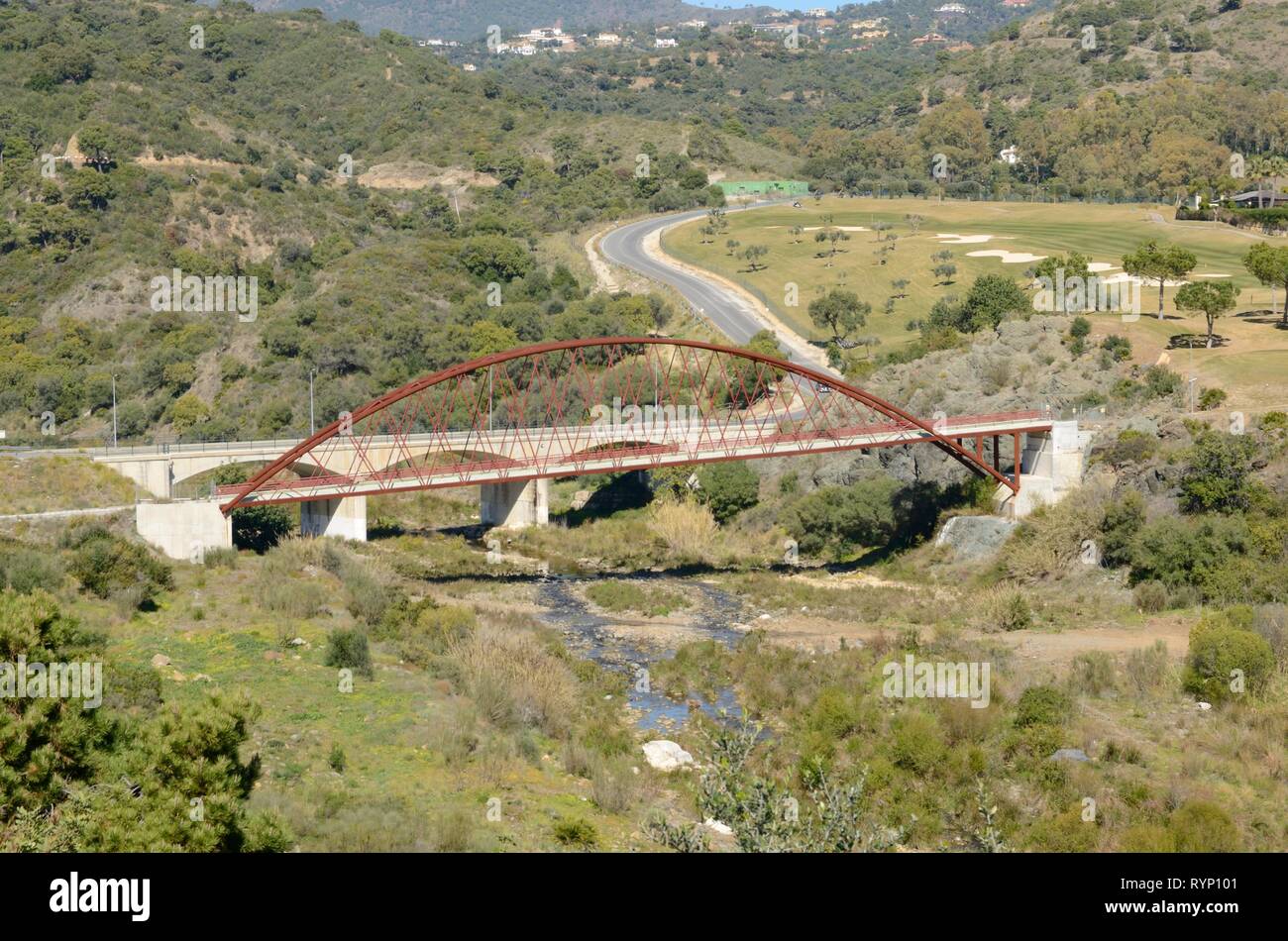 Red bridge at golf course in the valley of Benahavis, a village next to ...
