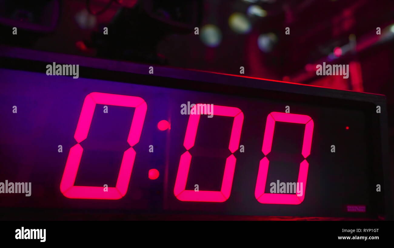 Three zeros on the clock timer on the wall inside the building with the ...