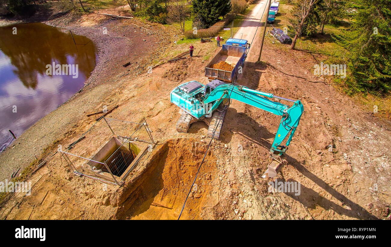 The 360 degrees aerial view of the backhoe and the forest. THe blue ...