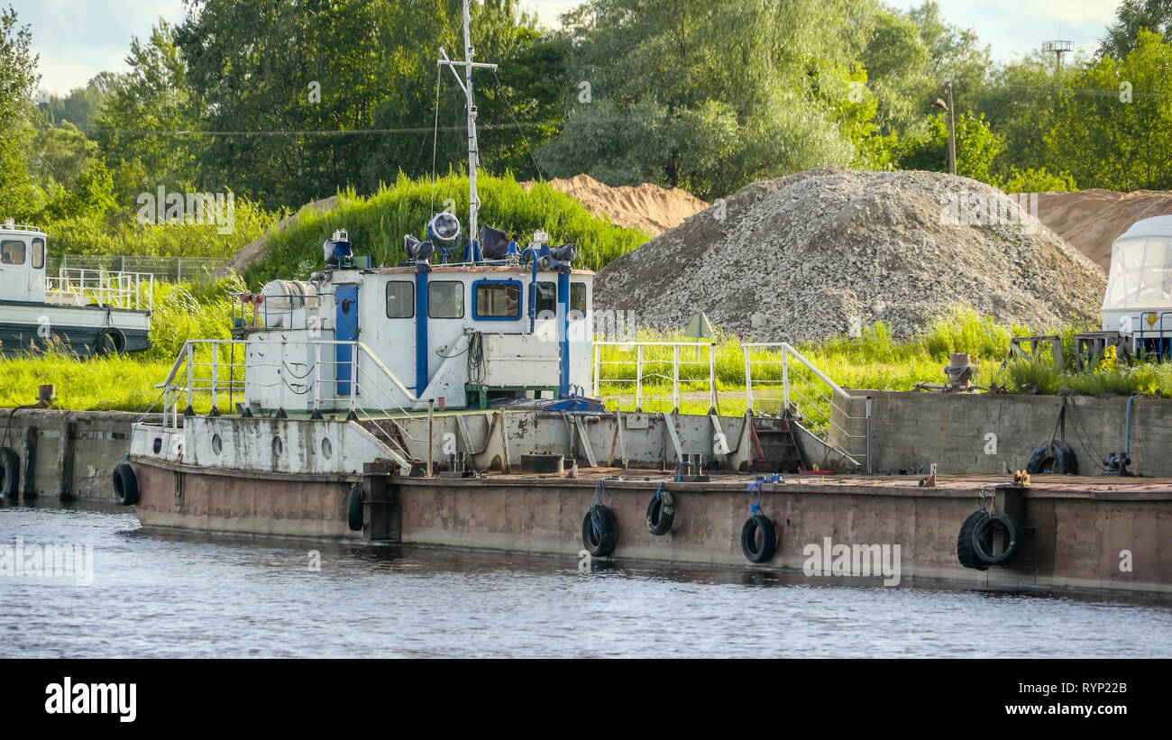 A big boat vessel docking on the port of the river in Tartu Estonia ...