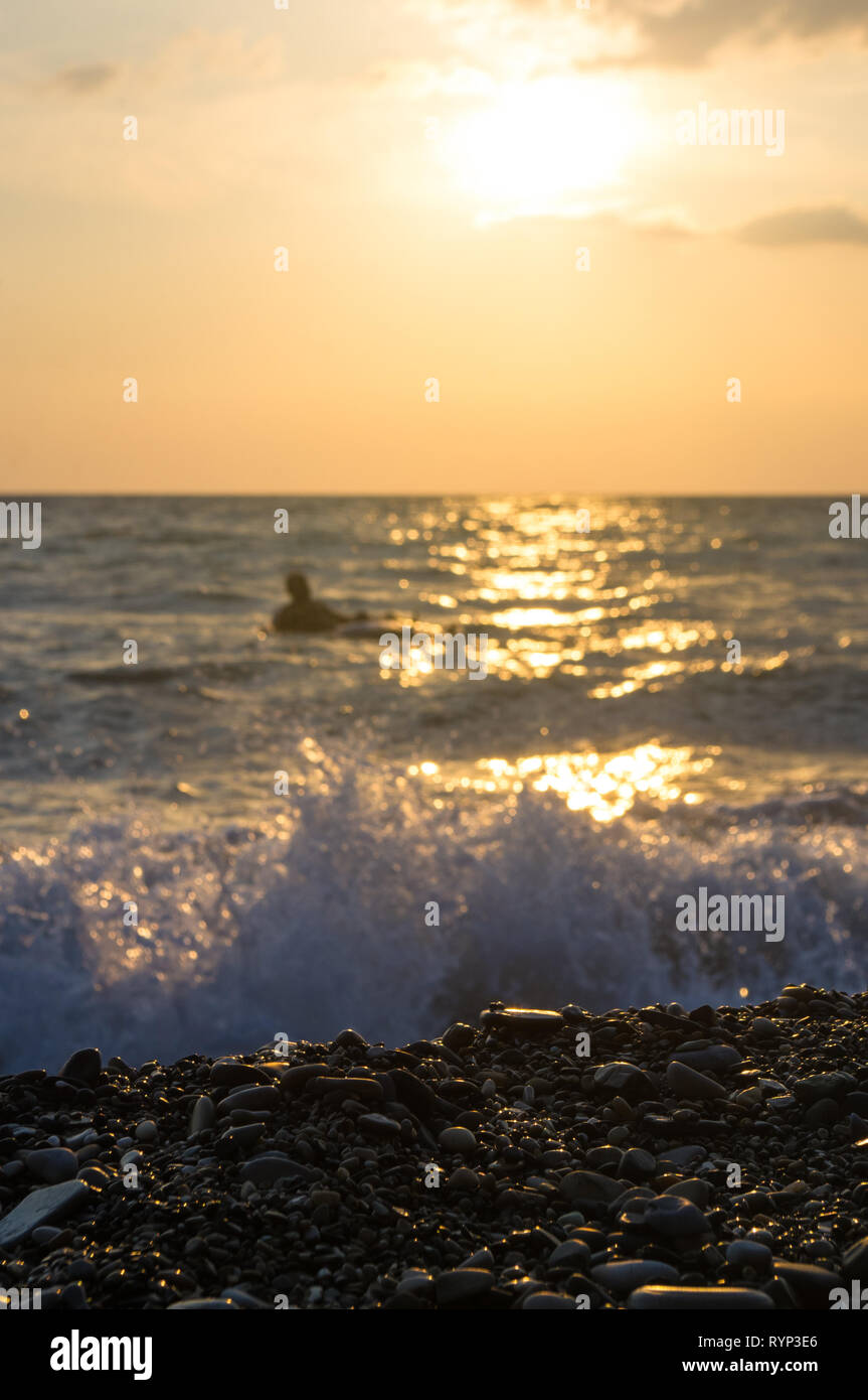 Amazing sea sunset on the pebble beach, the sun, waves, clouds Stock ...