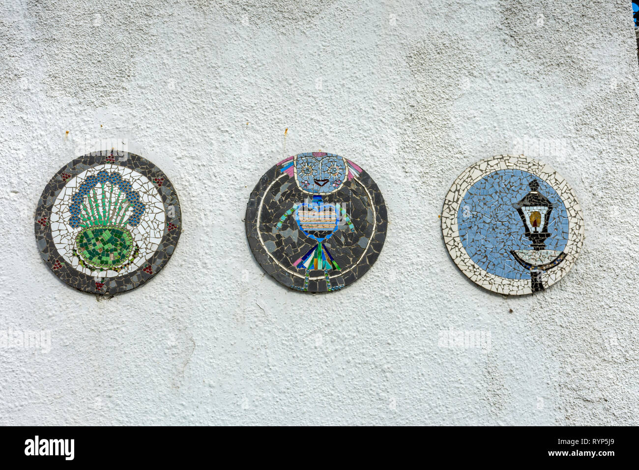 Decorative mosaic roundels on a wall, High Street, South Queensferry ...