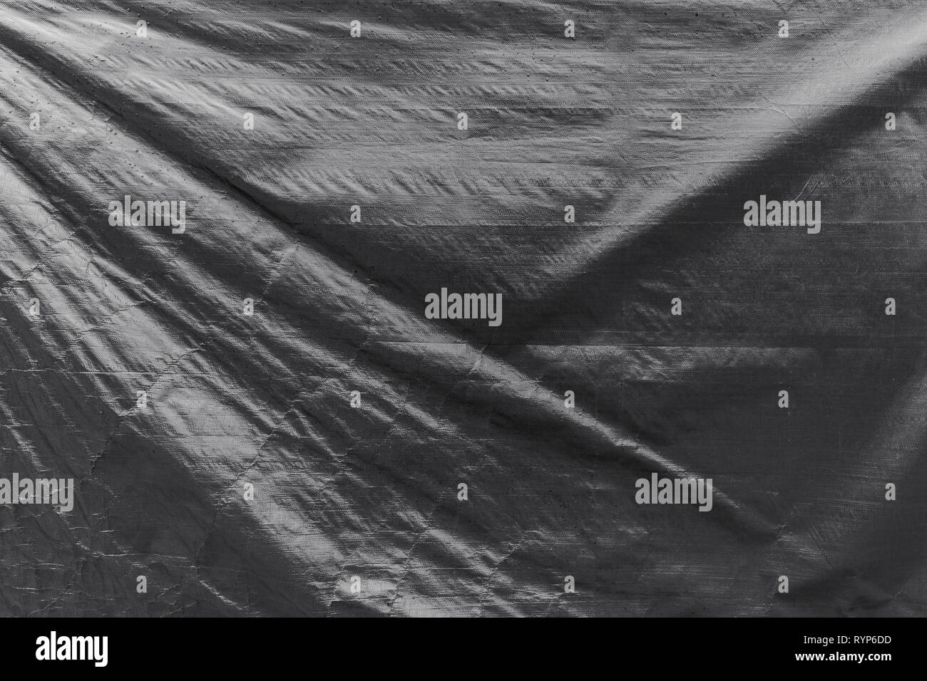Full frame background of a wrinkled tarp texture in black and white ...