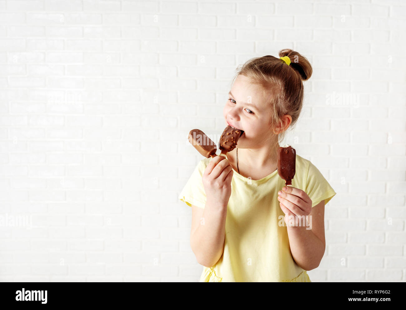 Girl child bite eat hi-res stock photography and images - Alamy