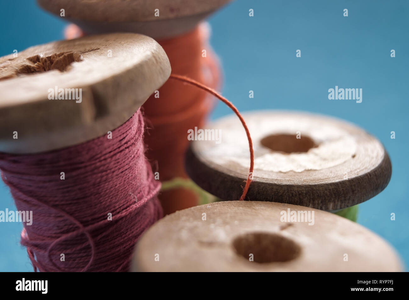 Sewing needle and cotton thread on wooden spool macro view Stock Photo ...