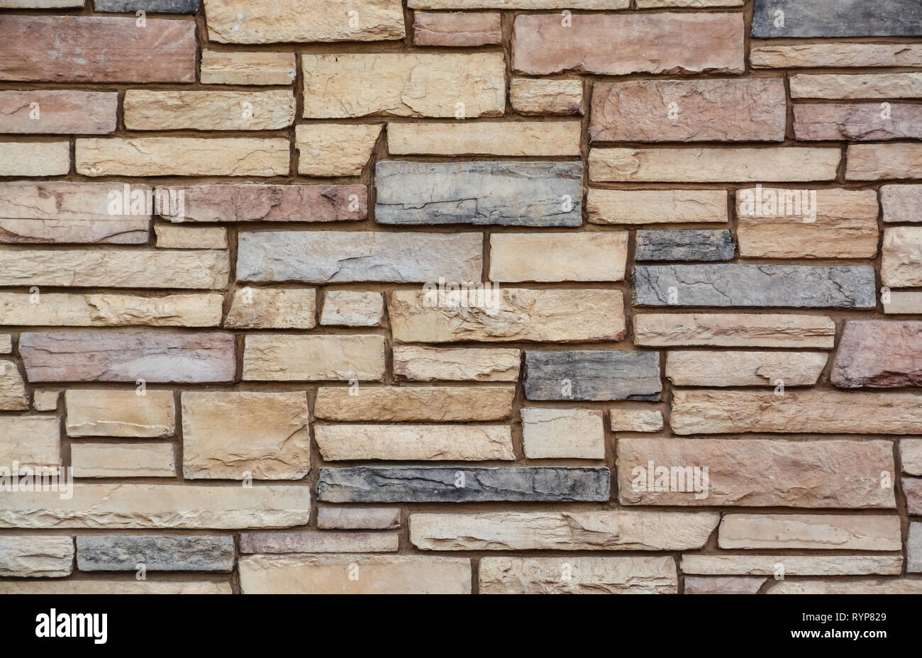 Brown colored stone setting. Cut stone wall texture Stock Photo - Alamy
