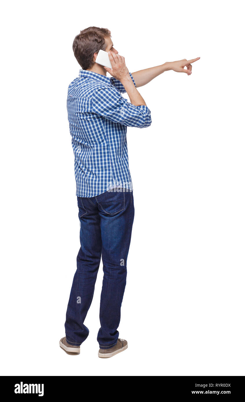 Back view of pointing young men talking on cell phone. Young guy ...