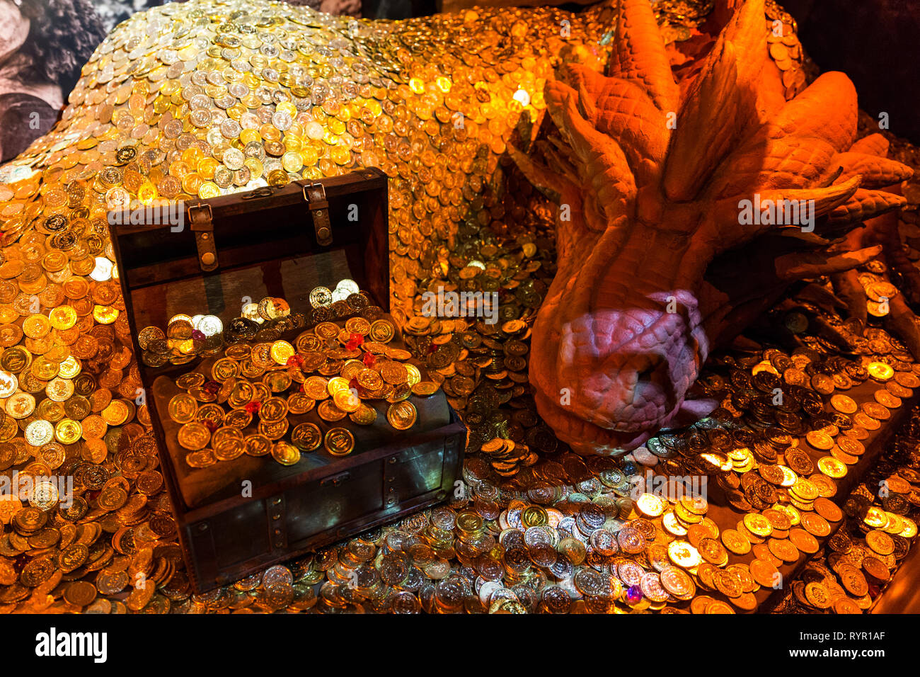 Red dragon hoarding treasures chests and piles of coins Stock Photo - Alamy