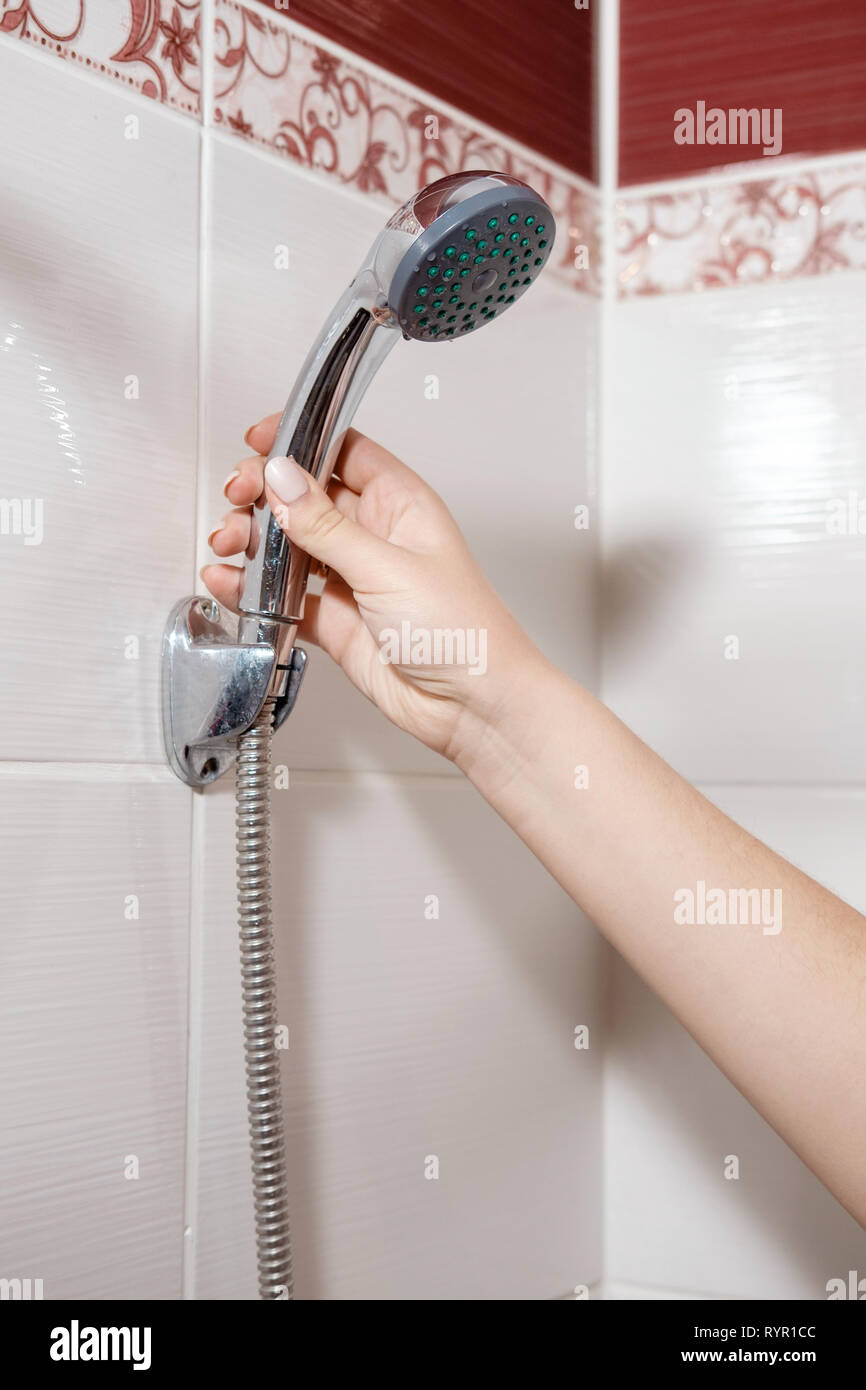 shower in female hand in bathroom Stock Photo - Alamy