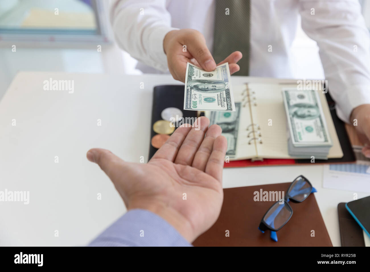 Business and finance concept, Hand of a businessman giving money to his ...