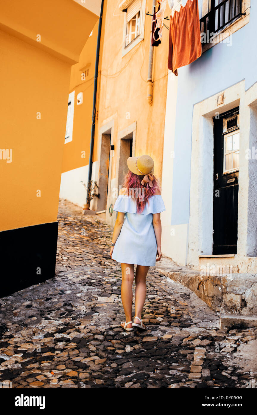 Young female tourist wearing generic dress taking a tour in southern ...