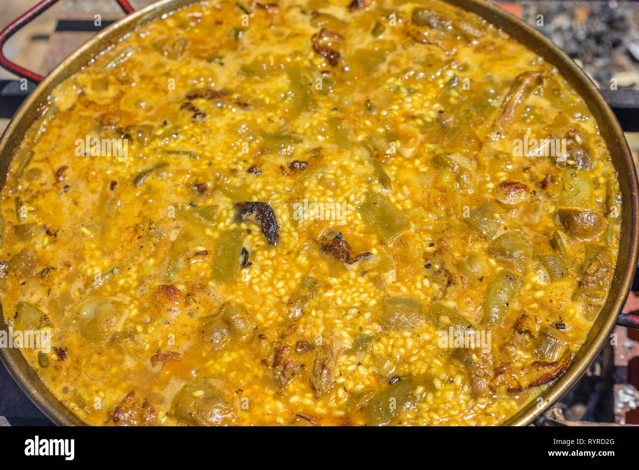 Making spanish traditional valencian Paella stir-frying Rabbit meat ...