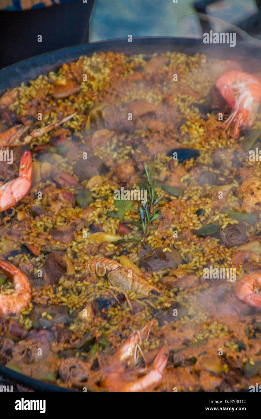 Spanish Paella cooked on natural log fire and coal in a traditional ...