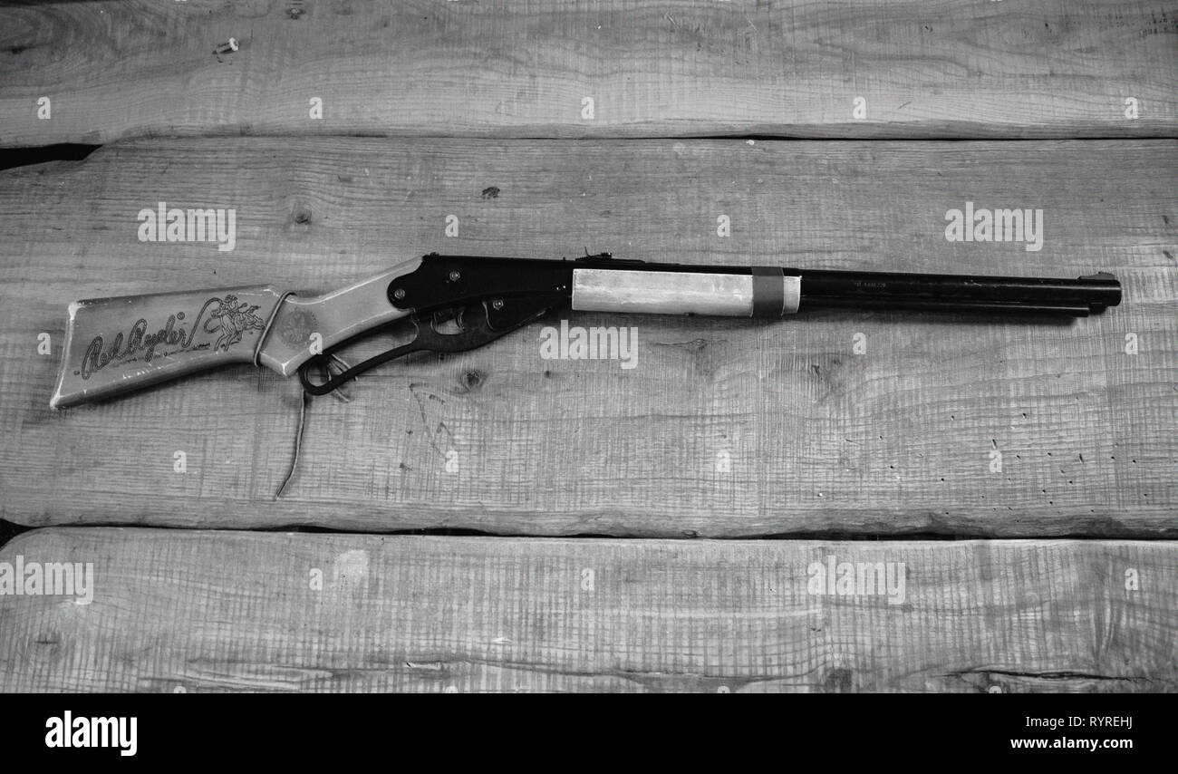 Red Ryder BB gun on wooden background. Black and white. Overhead shot ...