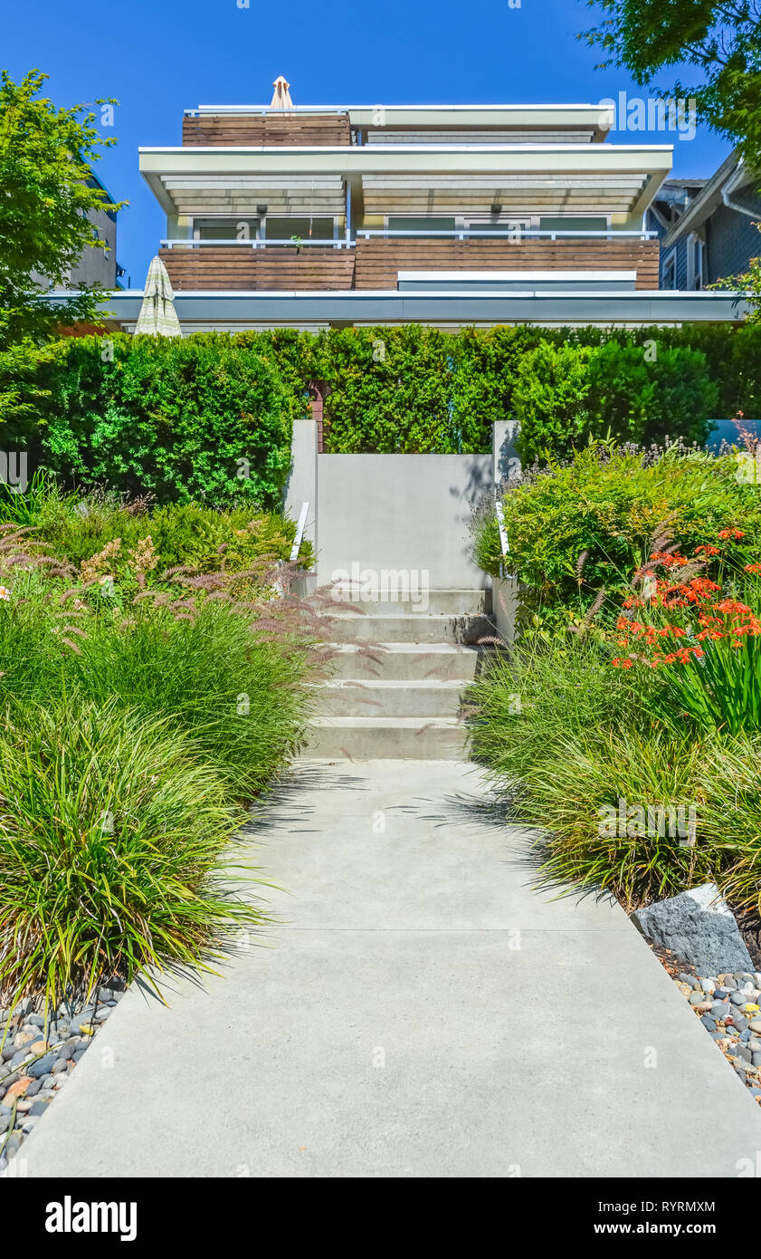 Concrete pathway to residential house on the trarrace over landscaped ...