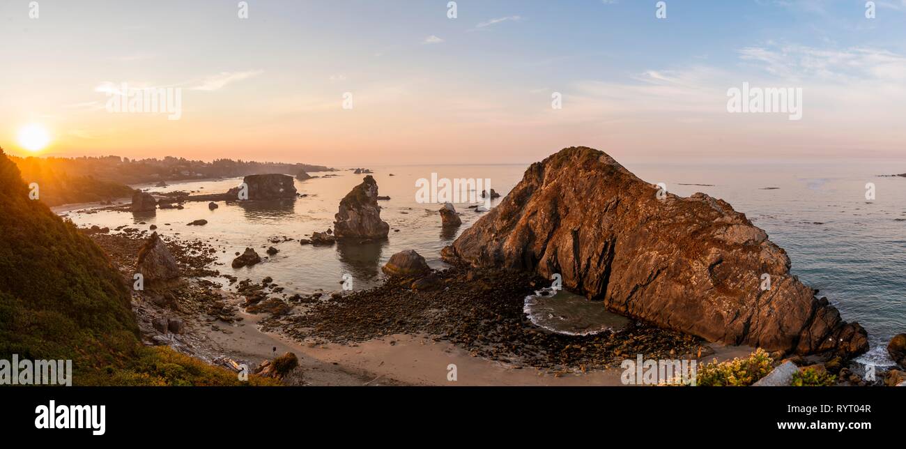 Sunrise, rugged coastal landscape with many rock islands, Arch Rock ...