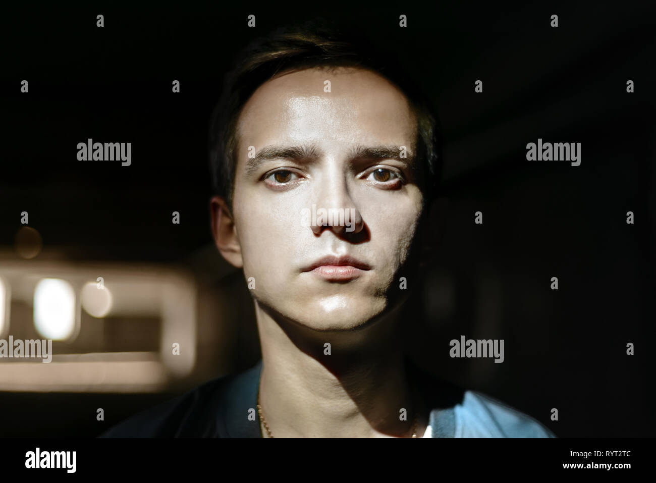 dramatic portrait of young man. dark background Stock Photo - Alamy