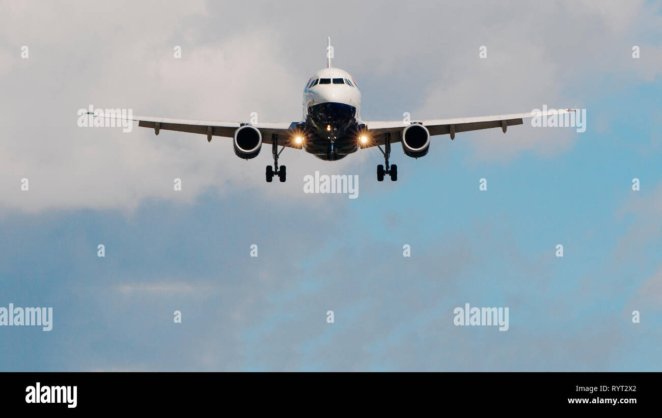 Airplane landing at the airport, front view with copy space Stock Photo ...
