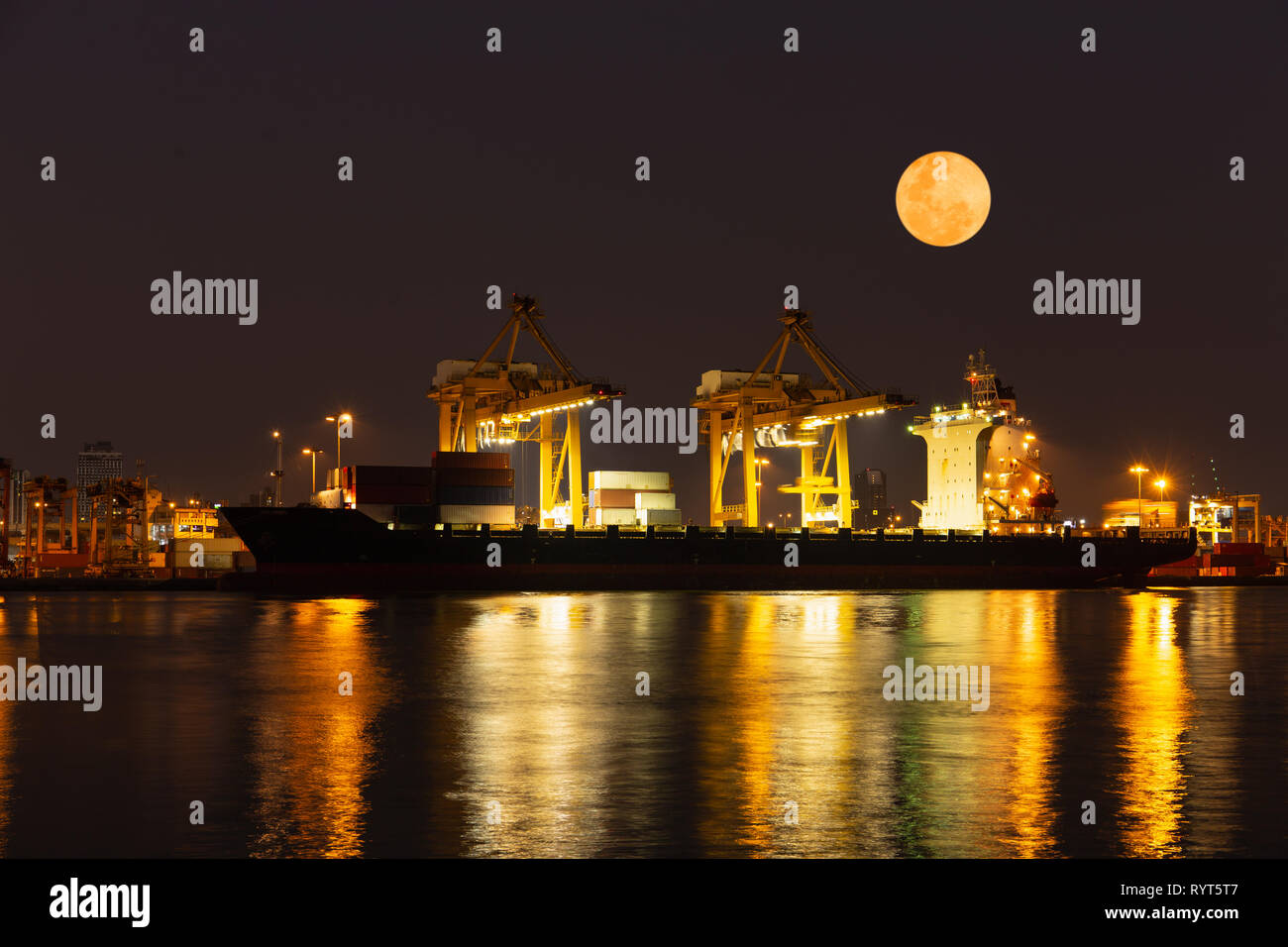 Super moon and cargo Containers loading Shipping by crane at night time ...