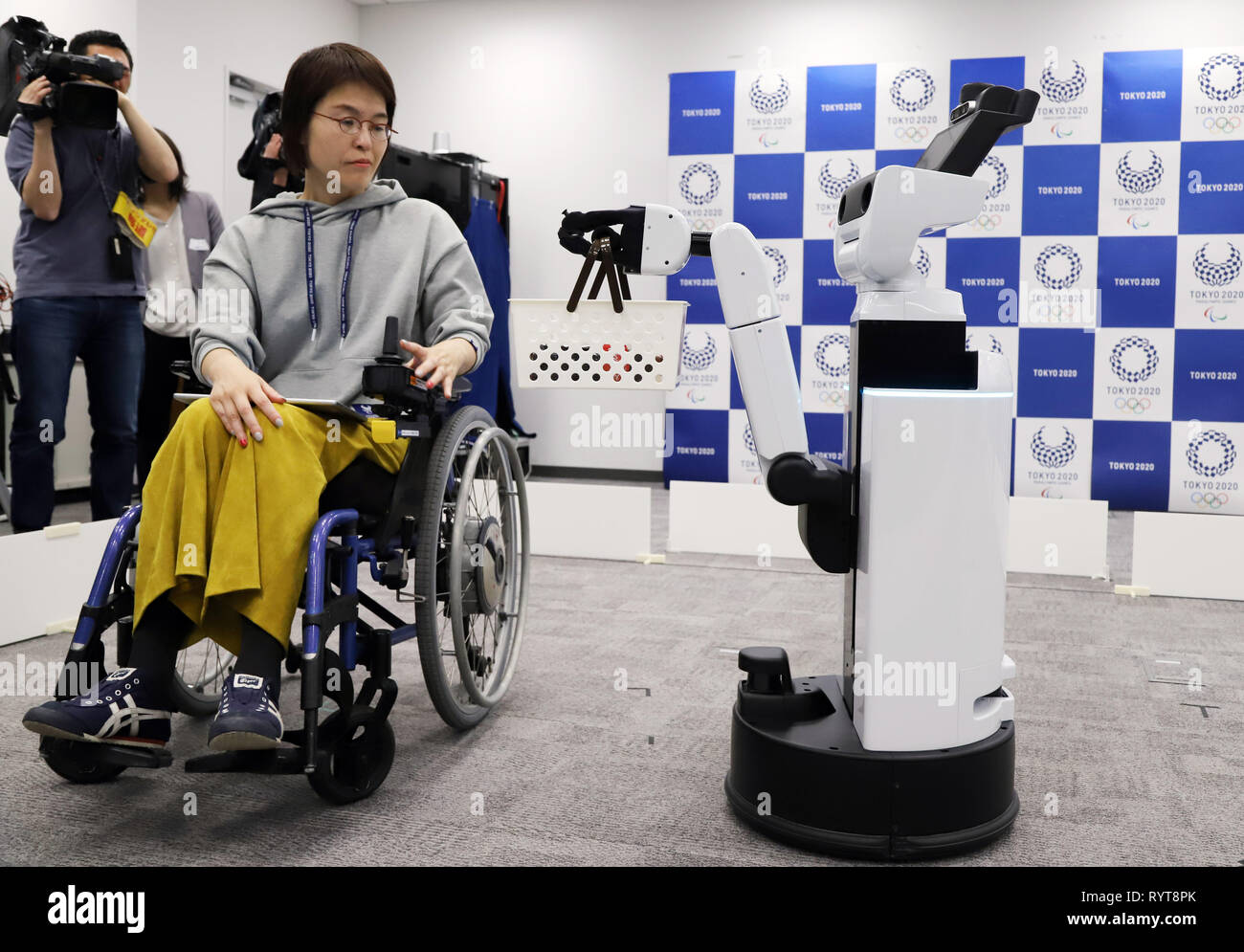 Tokyo, Japan. 15th Mar, 2019. A woman on a wheelchair receives a basket ...