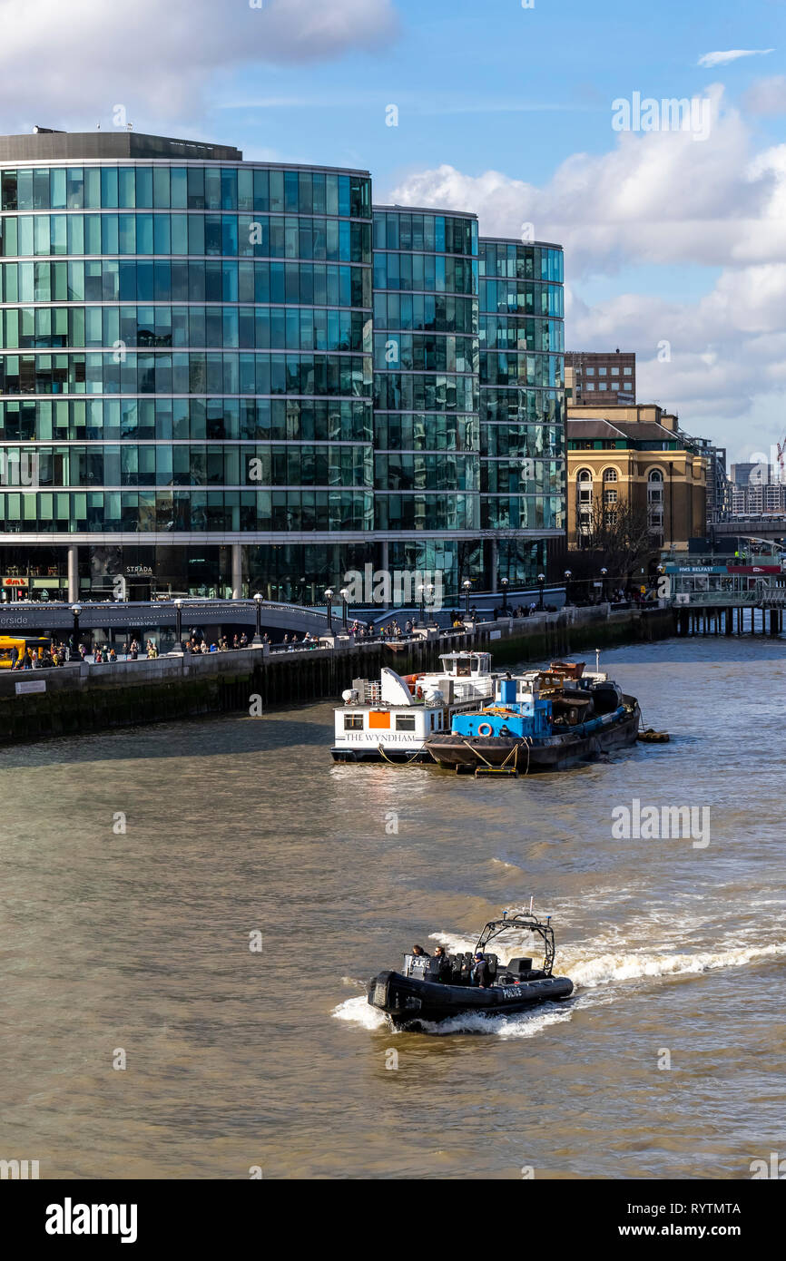 Metropolitan Police river launch on the River Thames at Tower Bridge ...