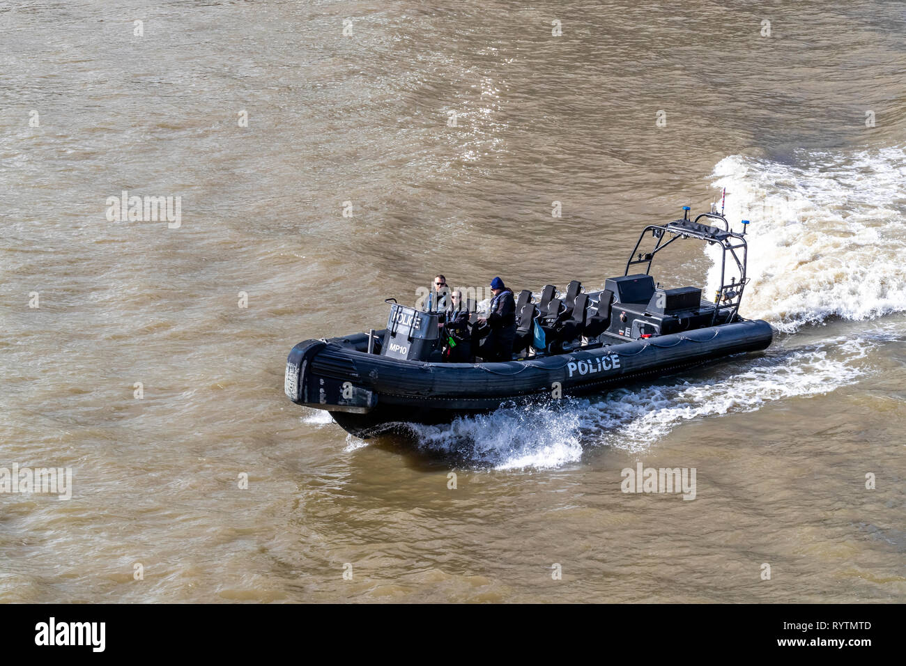 Metropolitan Police river launch on the River Thames at Tower Bridge ...